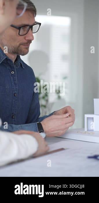 Architectural professionals reviewing blueprints on a desk with a ...