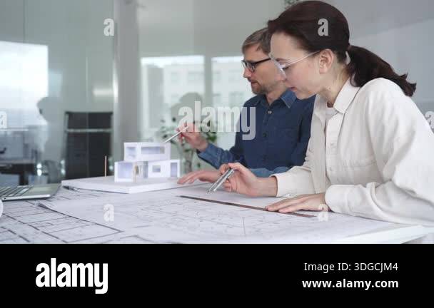 Architects developing a new building project, collaborating and ...