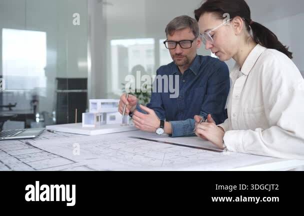 Architects developing a new building project, collaborating and ...