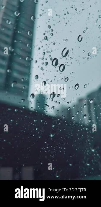 Raindrops on car window during rain urban view, Water droplets on glass ...