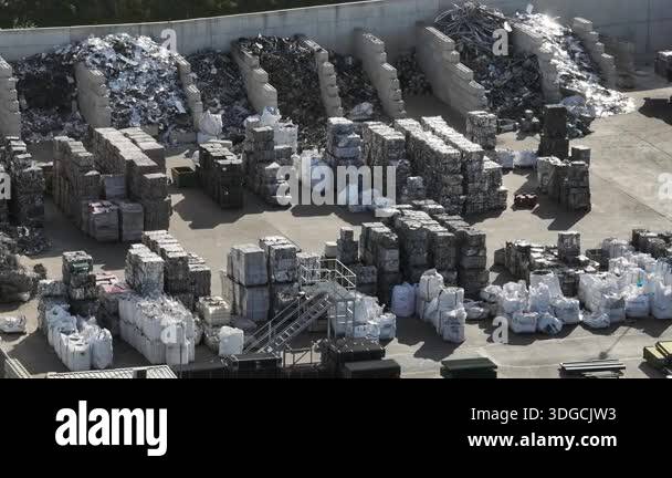 Aerial view of a metal recycling plant showcasing organized piles of ...