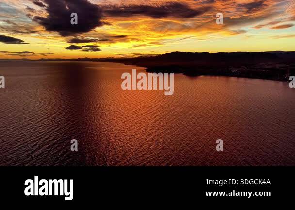 burning sky over island inlet, drone perspective captures fishing route ...