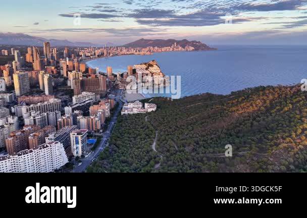 aerial headland overlooking city and bay at sunrise forested ridge ...