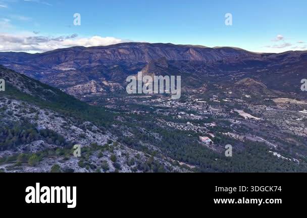 sunlit ridge overlooking sprawling valley and distant plateau with ...