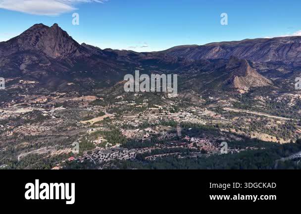 aerial view wide valley and towering mountain, sprawling towns and ...