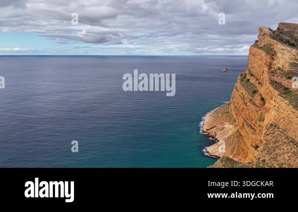 aerial cliff edge and vast open ocean, panoramic drone shot capturing ...