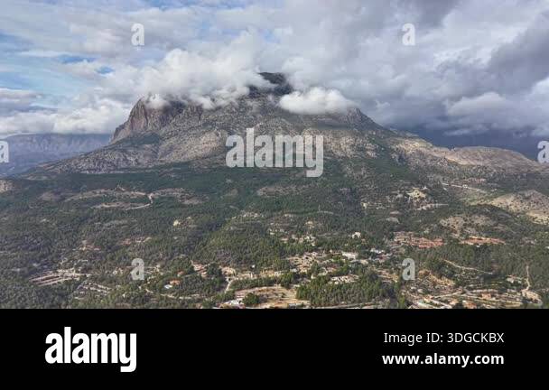 cloud capped summit under storm clouds, dramatic granite cliffs ...