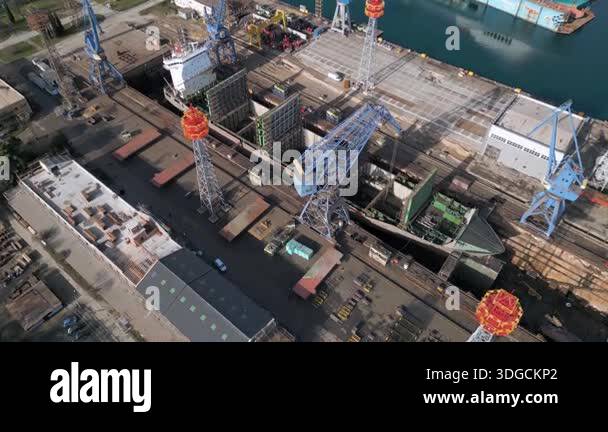 Aerial view of a ship repair yard with dry docks, cranes, and cargo ...