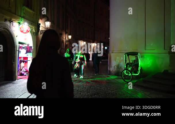 Night scene in Prague Old Town with neon rickshaw and pedestrians ...
