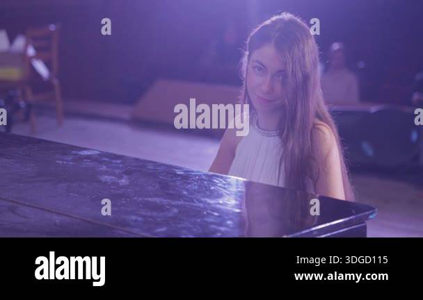 Young Woman in White Dress Passionately Plays Piano on Stage Under ...