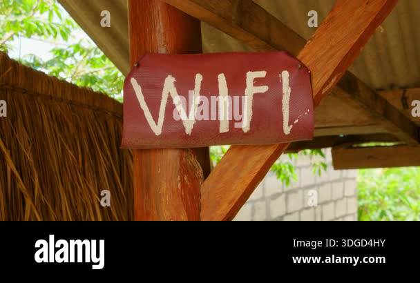 Red free wifi sign mounted on wooden structure at cafe in Indonesia ...