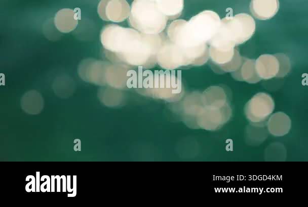 Blurred light reflecting on calm turquoise sea water creating artistic ...