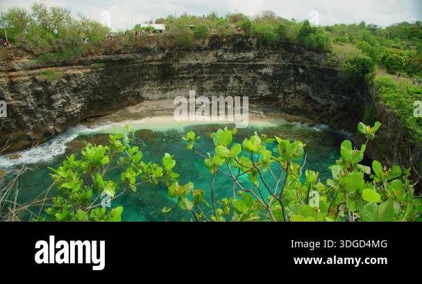 Wide view of circular rock bay at Broken Beach with clear turquoise ...