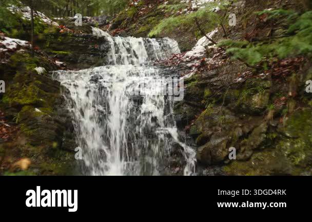 Beautiful mountain small waterfall in forest at early spring time ...