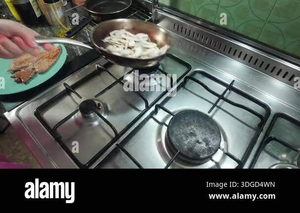 Professional chef preparing a delicious side dish by sauteing sliced ...
