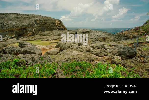 Rocky coastal landscape with ocean horizon and visitors on Angel ...