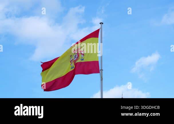 Low angle view of the national flag of Spain waving proudly in the wind ...