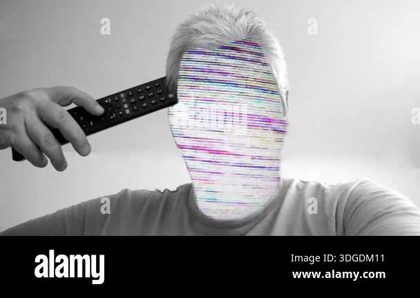 Man whose face is replaced by television static holding a remote ...