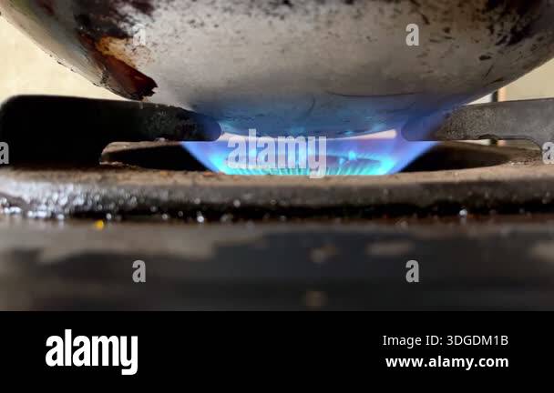 Close-Up of Blue Gas Flame Burning on Kitchen Stove Underneath a ...