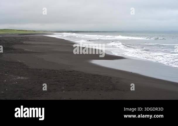 Witness the enchanting waves gently caressing the shores of Kunashir ...