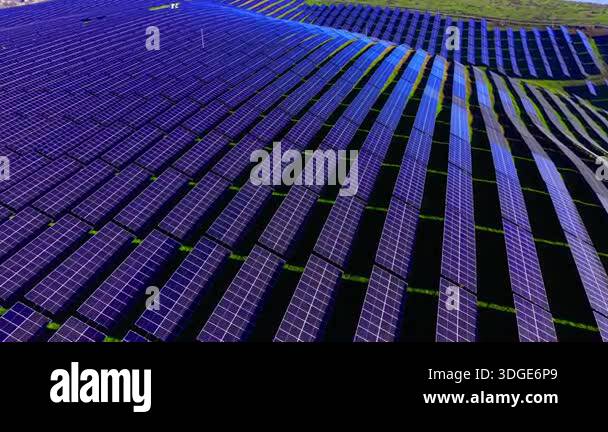High angle perspective showing rows of dark blue solar panels curving ...