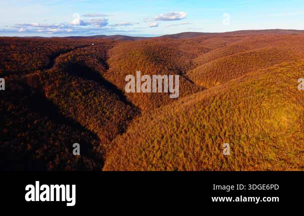 Dramatic aerial perspective of a V-shaped valley filled with colorful ...