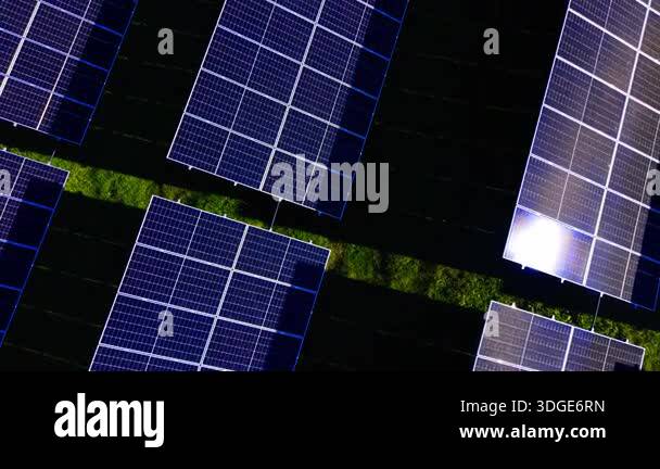 Top-down perspective of solar modules showing a bright sun reflection ...