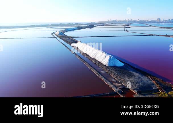 A wide scenic view of the salt production area during sunset. Large ...