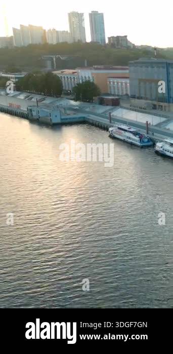 Multiple passenger ships are docking at a concrete embankment in a ...