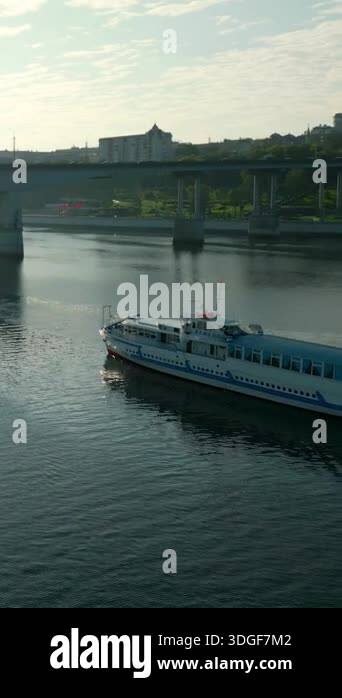 White passenger ferry navigating on moskva river under bridge at ...