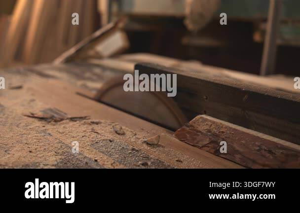 CloseUp Rotating Circular Saw Blade Rising From Dusty Table, Aggressive ...