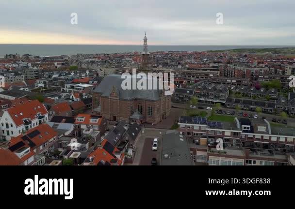 Aerial view of Dutch coastal town with historic church, red-tiled ...