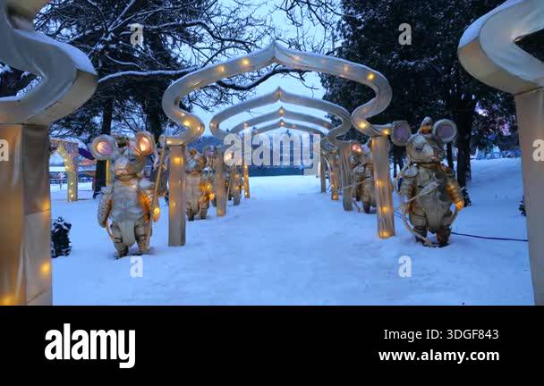 LVIV, UKRAINE - JANUARY 06, 2026: Golden mouse guards illuminate a ...