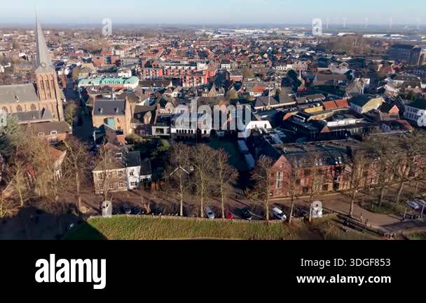 Aerial view of European town with red rooftops, winding streets, church ...