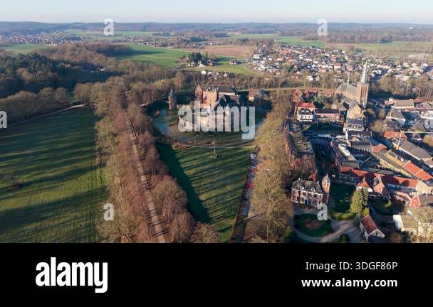 Aerial view of European town with medieval castle, moat, church spire ...