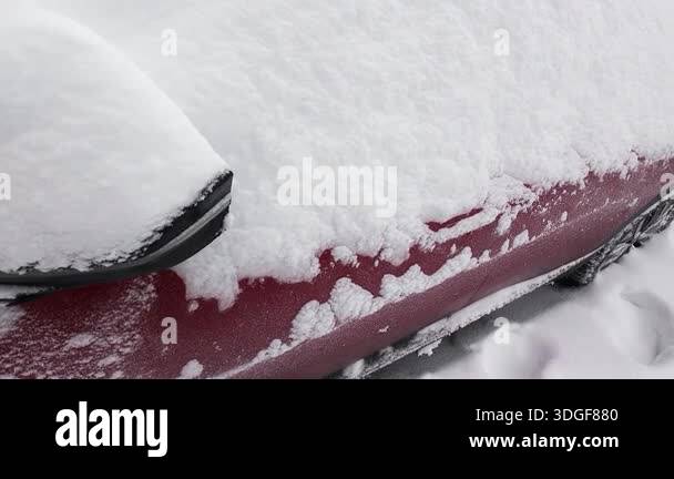 A vehicle is completely buried in a thick layer of snow. The aftermath ...