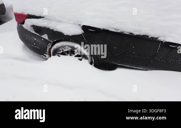 Cars covered in deep snow after a winter blizzard. Vehicles stuck on a ...