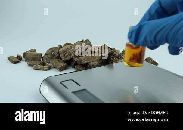 essential oil bottle , chemical beaker , flask on digital scale white ...