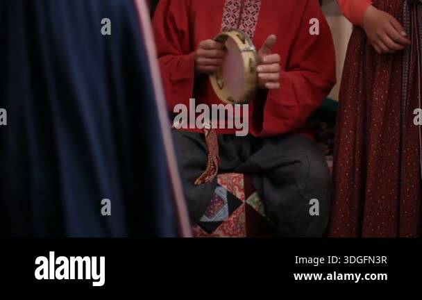 Russian folk musical group - man in traditional costumes plays musical ...