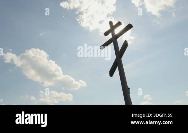 Wooden orthodox Cross in front of blue sky - Time Lapse - telephoto ...