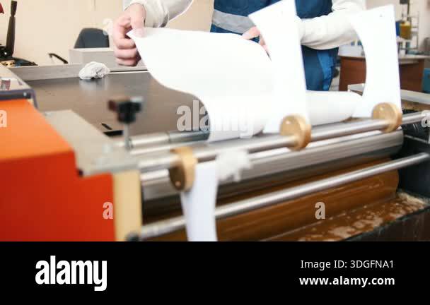 Polygraphic process in a modern printing house, printed sheet of paper ...