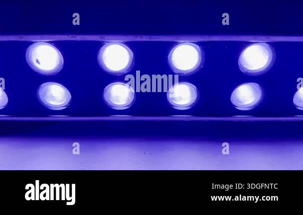 glowing led light bar row in deep purple ambiance dark studio closeup ...