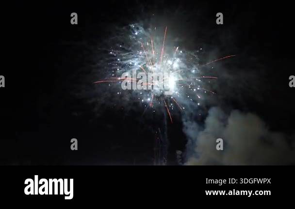 4K video of a vibrant fireworks display lighting up the night sky. The ...