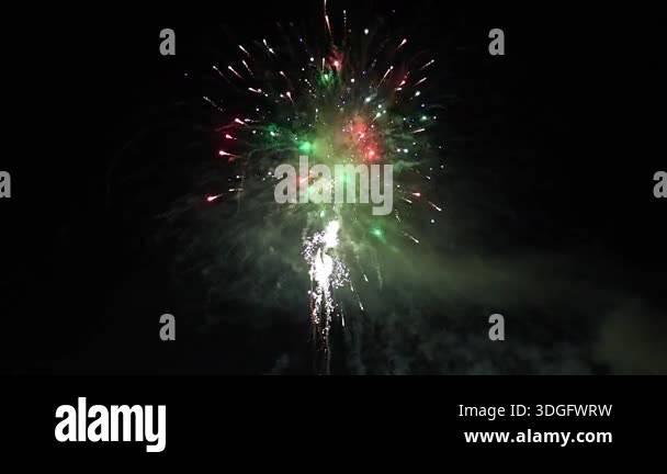 4K video of a vibrant fireworks display lighting up the night sky. The ...