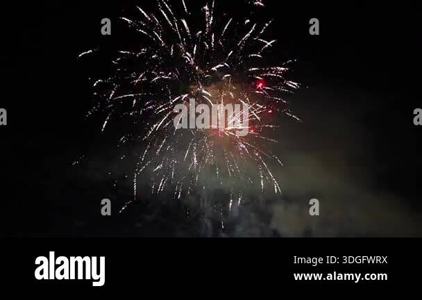 4K video of a vibrant fireworks display lighting up the night sky. The ...