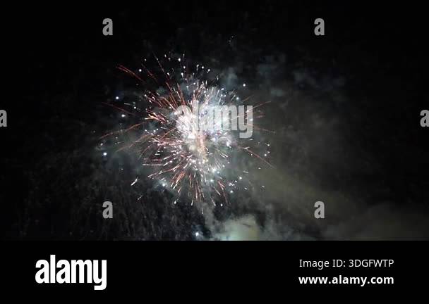 4K video of a vibrant fireworks display lighting up the night sky. The ...