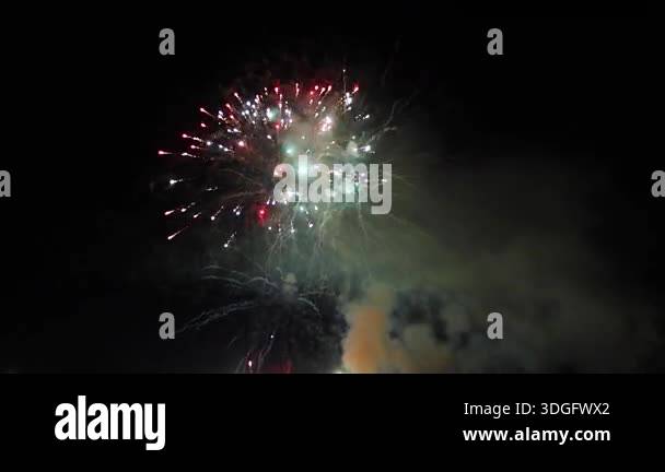 4K video of a vibrant fireworks display lighting up the night sky. The ...
