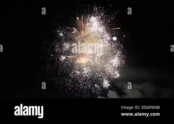 4K video of a vibrant fireworks display lighting up the night sky. The ...