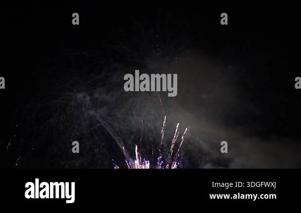 4K video of a vibrant fireworks display lighting up the night sky. The ...