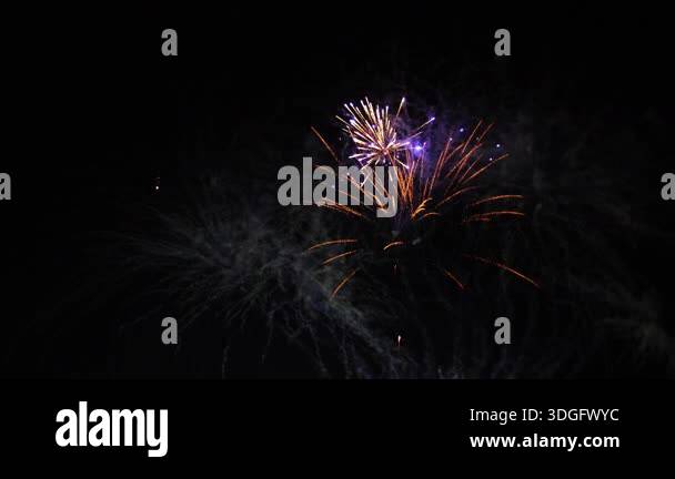 4K video of a vibrant fireworks display lighting up the night sky. The ...